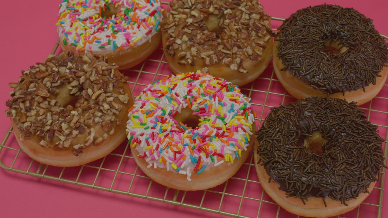 Six glazed donuts of various flavors - Free Stock Video