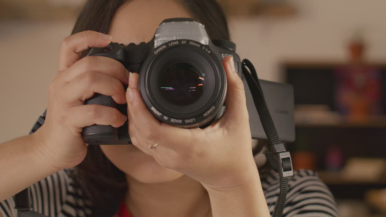 Portrait of a woman taking a photo with a camera - Free Stock Video