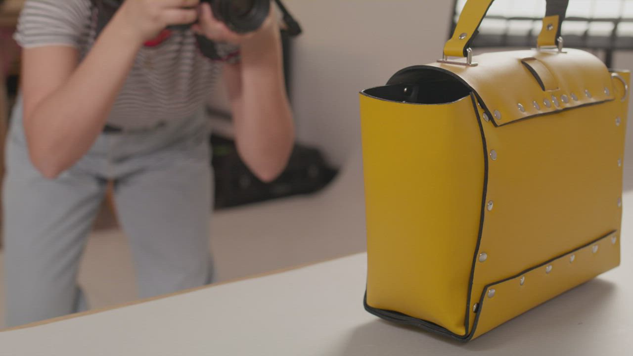 Woman taking pictures of a bag - Free Stock Video