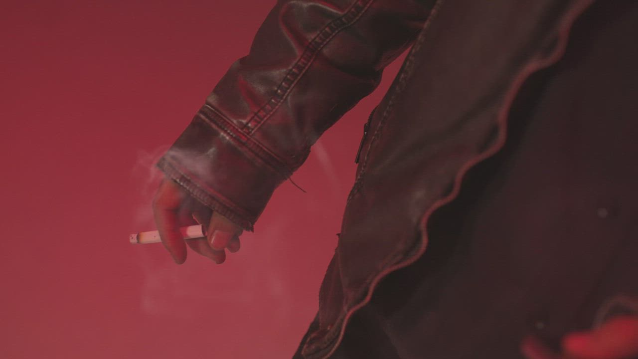 Man dressed as a devil smoking a cigarette - Free Stock Video