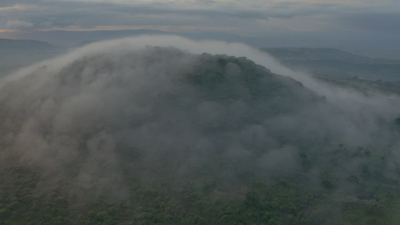 Flying over a mist covered hill - Free Stock Video