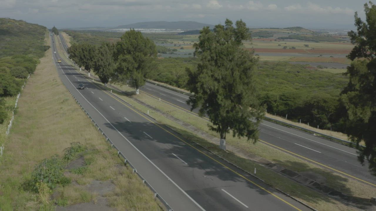 Aerial shot of a long highway that crosses the nature - Free Stock Video