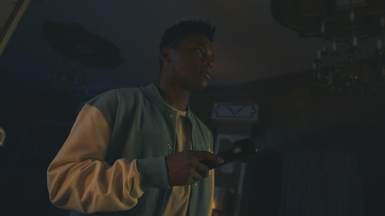 Man with a flashlight exploring a haunted house - Free Stock Video