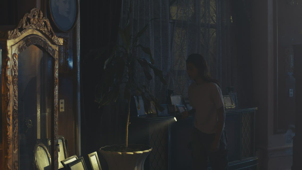Girl exploring a haunted mansion at night - Free Stock Video