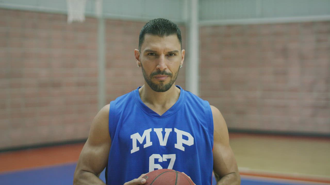 Portrait of a strong basketball player with a ball - Free Stock Video