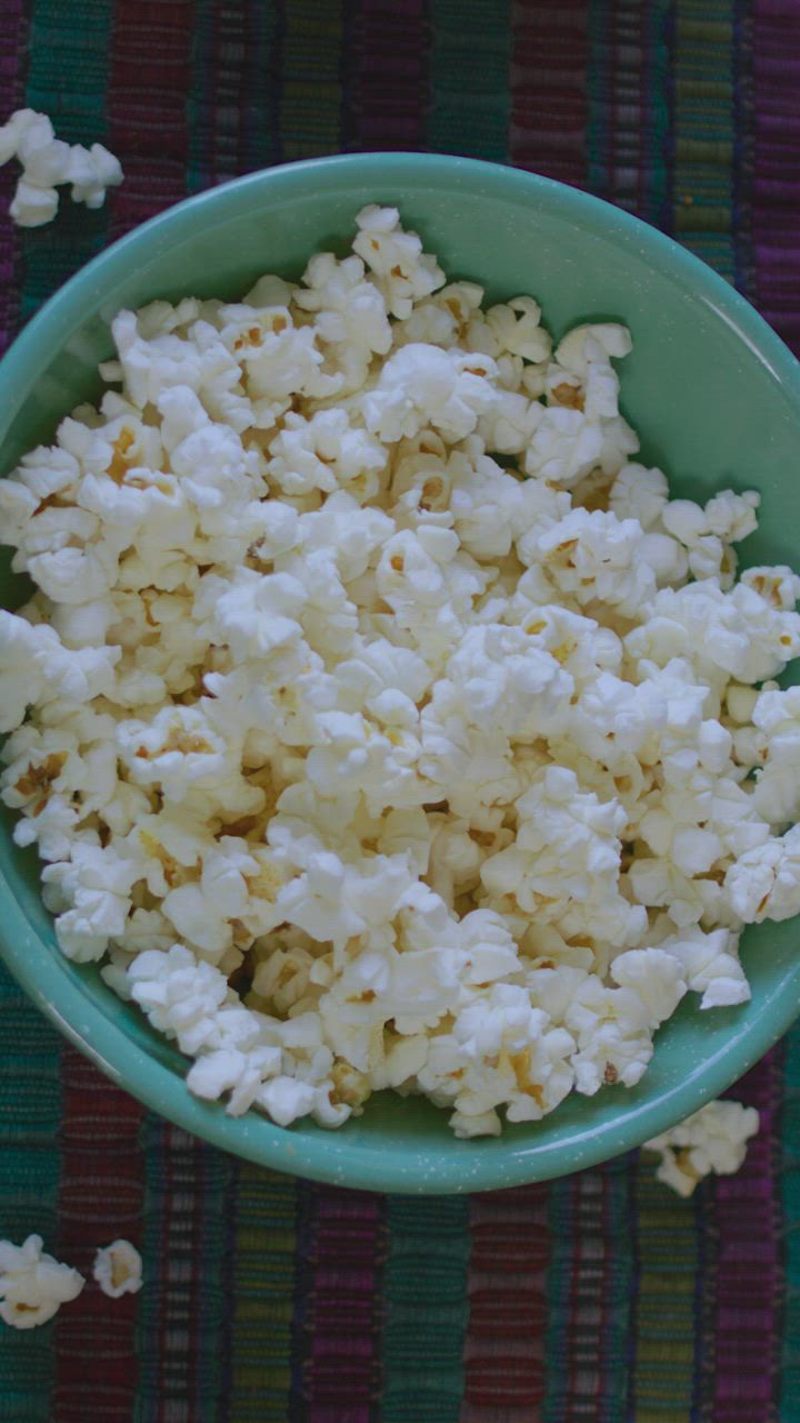 Friends taking popcorn from a bowl - Free Stock Video