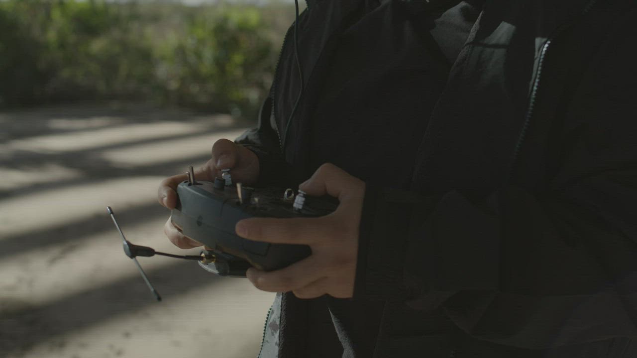 Close up view of a man controlling a drone outdoors - Free Stock Video