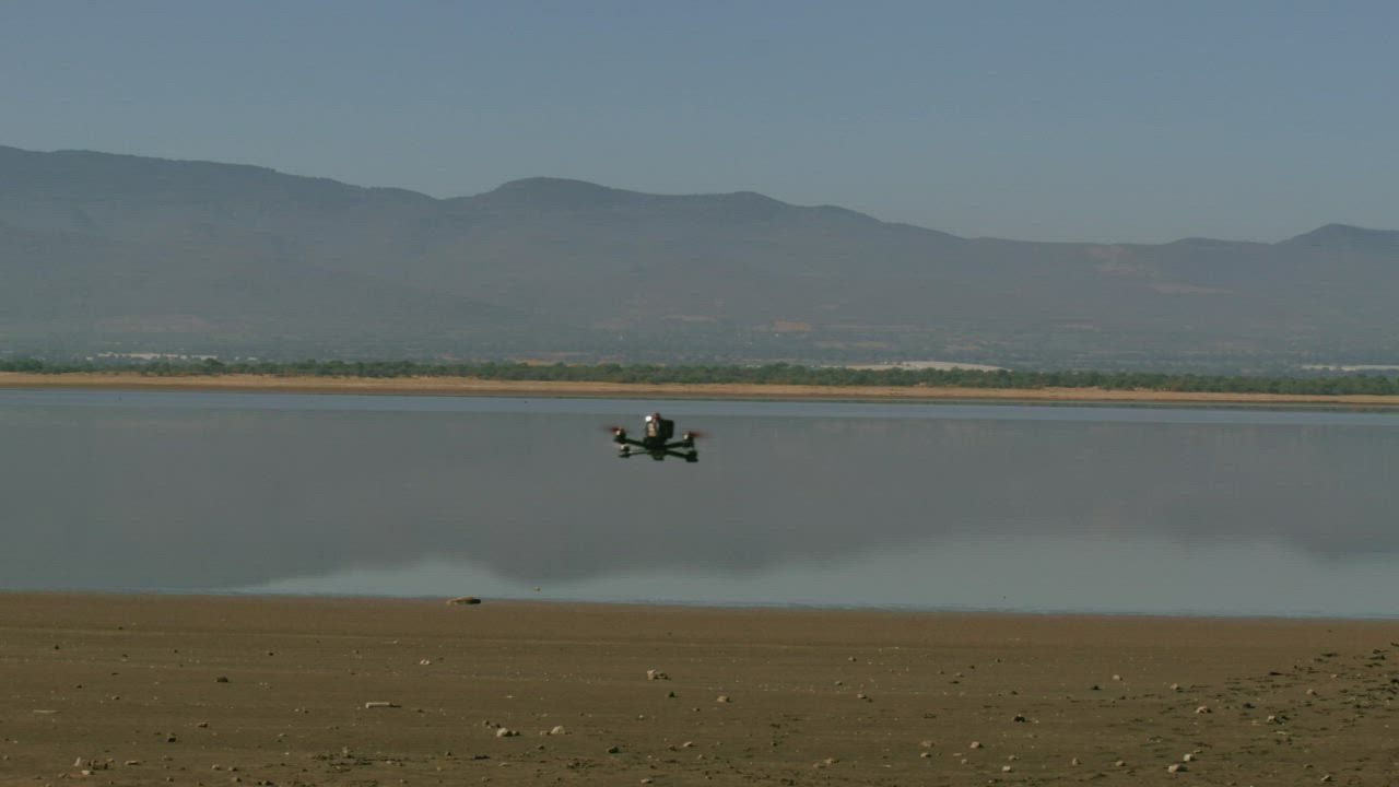 Little drone flying above a lake - Free Stock Video