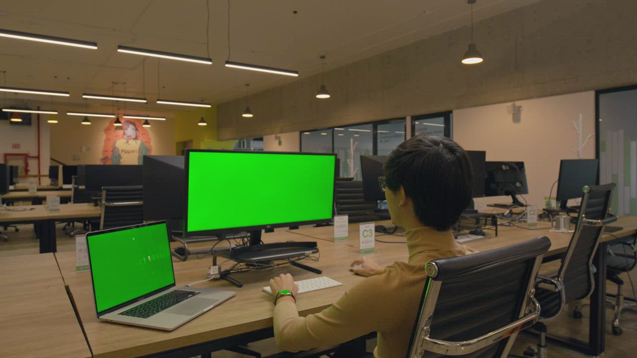 Man working on computer with chroma green background - Free Stock Video