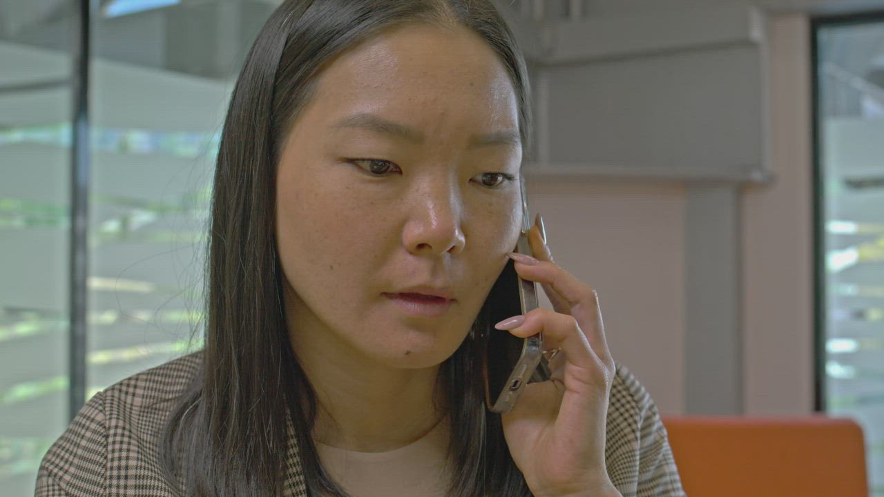 Portrait of a woman on a phone call in her office - Free Stock Video
