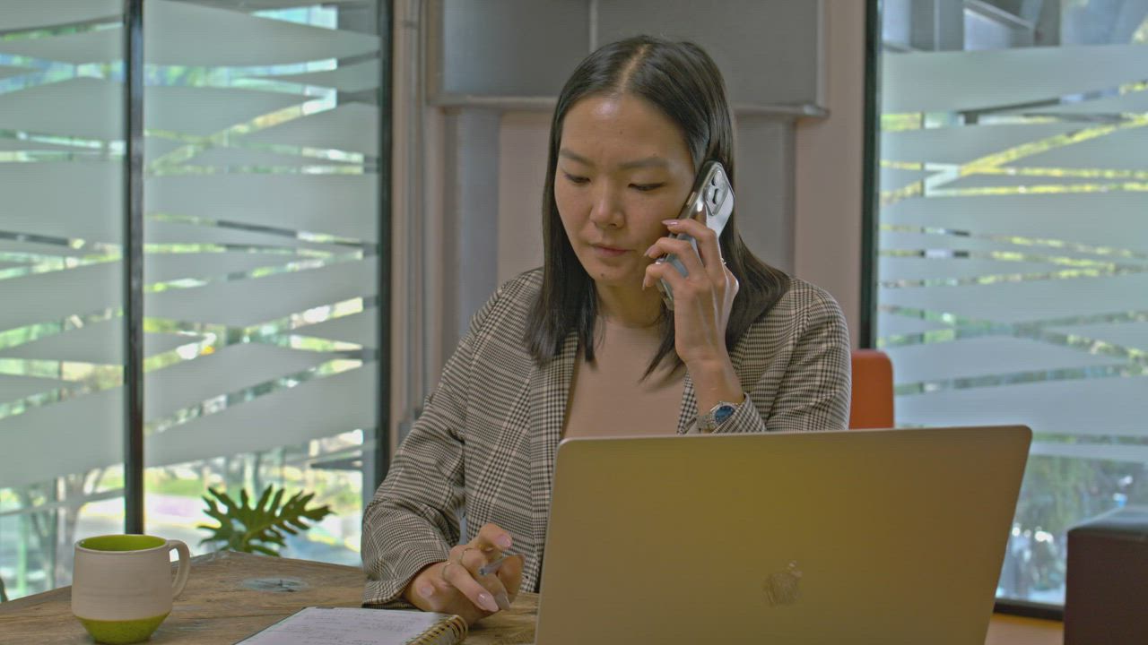 Professional woman on a call in her office - Free Stock Video