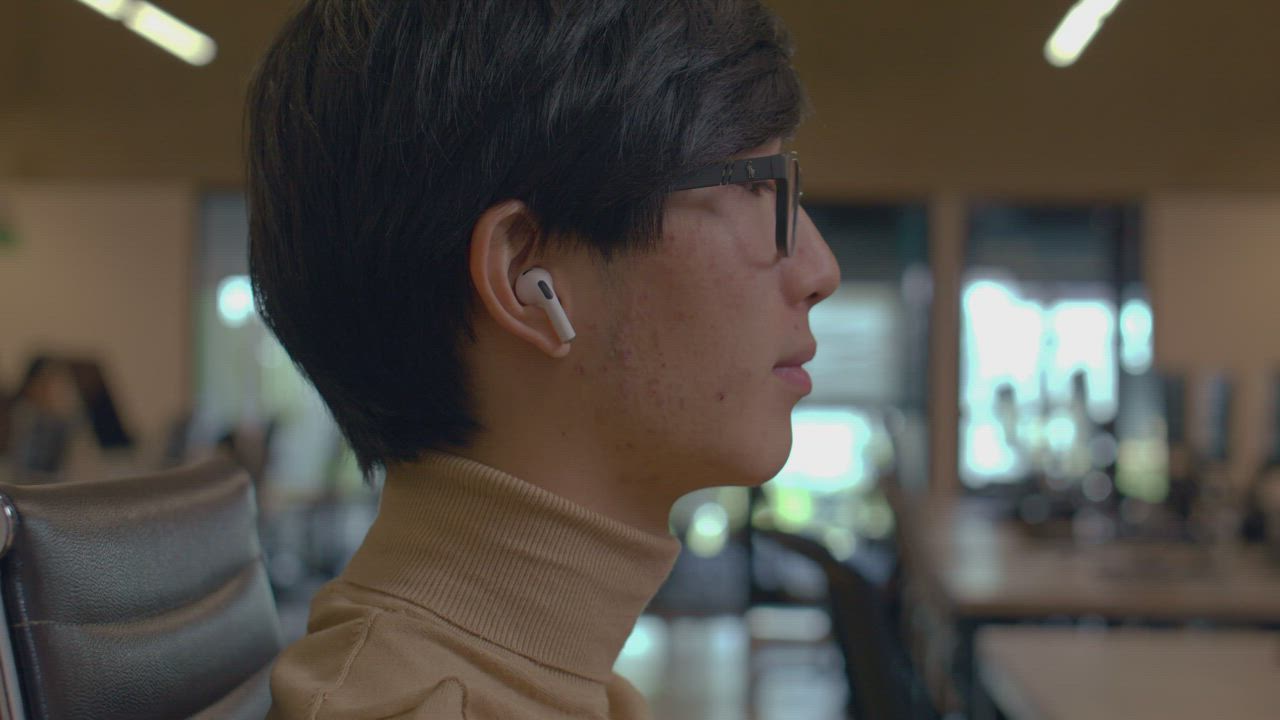 Young man taking off his wireless headphones - Free Stock Video