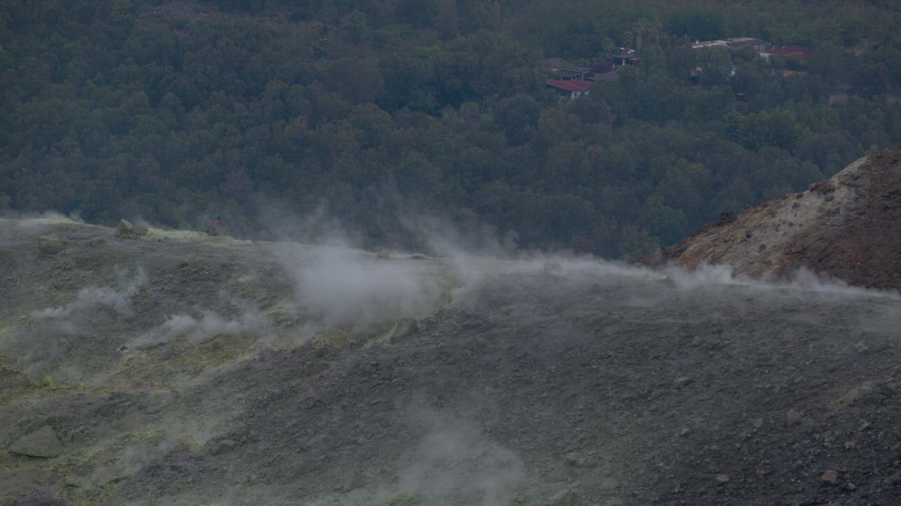 A volcano as smoke rises from the ground - Free Stock Video