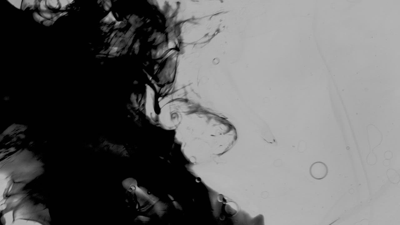 Abstract video of a liquid with dark ink flowing - Free Stock Video