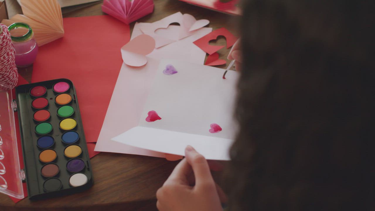 Painting hearts on a Valentine's card - Free Stock Video