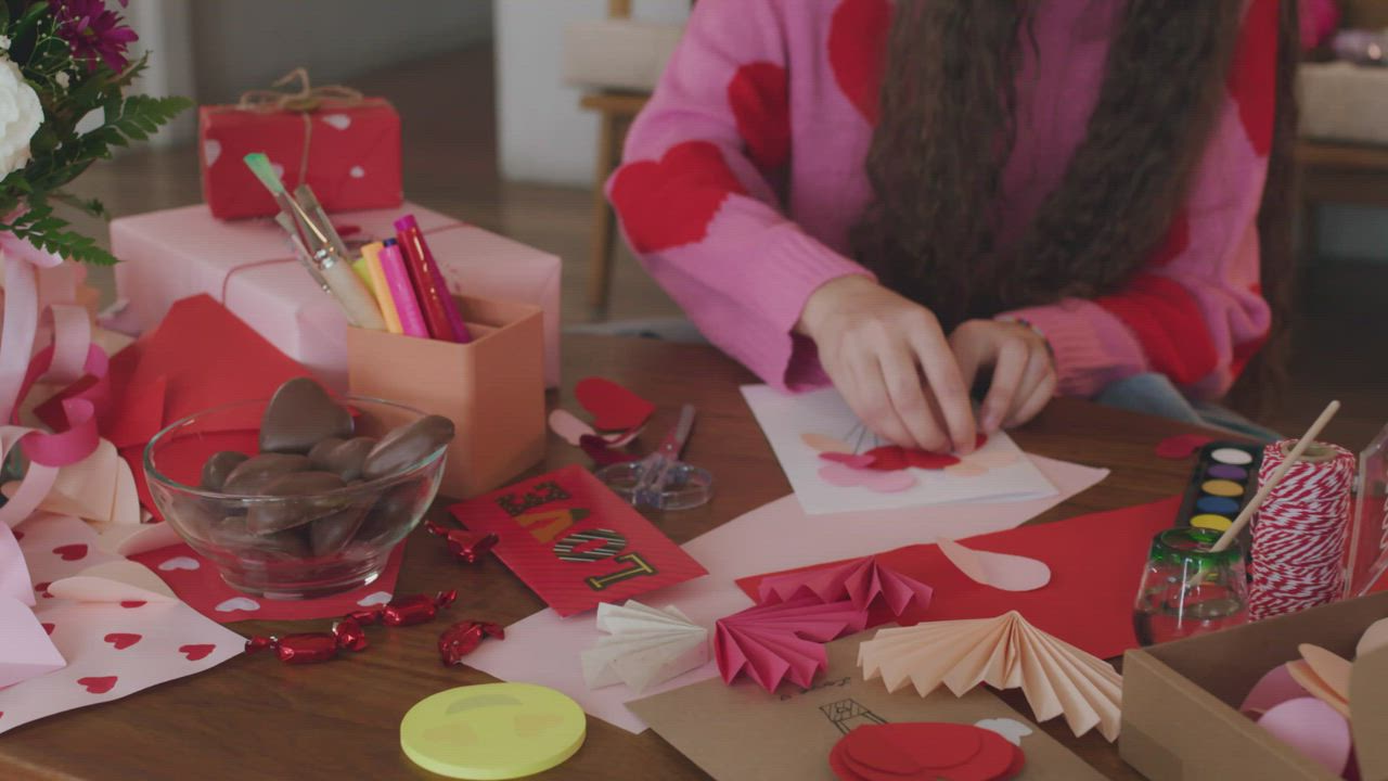 Creative girl making a decorated valentine's card - Free Stock Video
