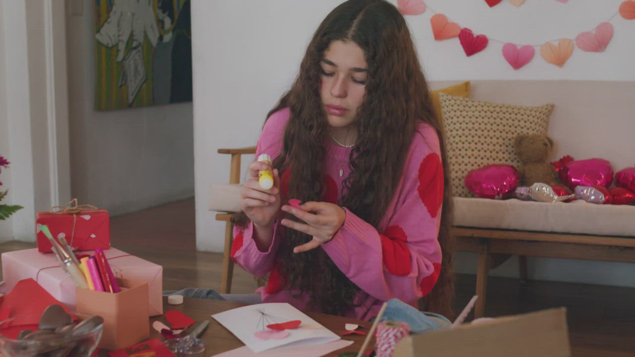 Girl making a decorated valentine's card - Free Stock Video