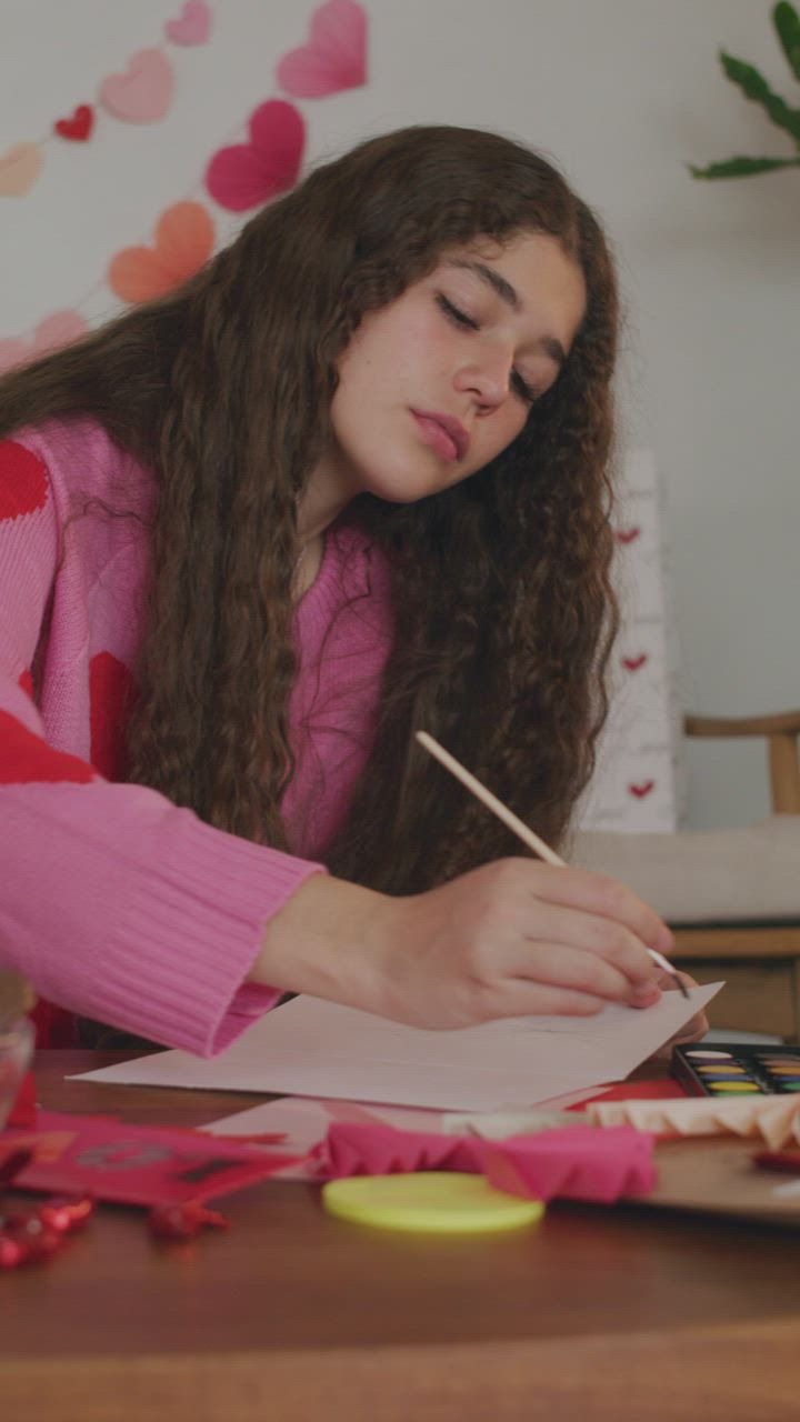 Creative girl making a card for valentine's day - Free Stock Video