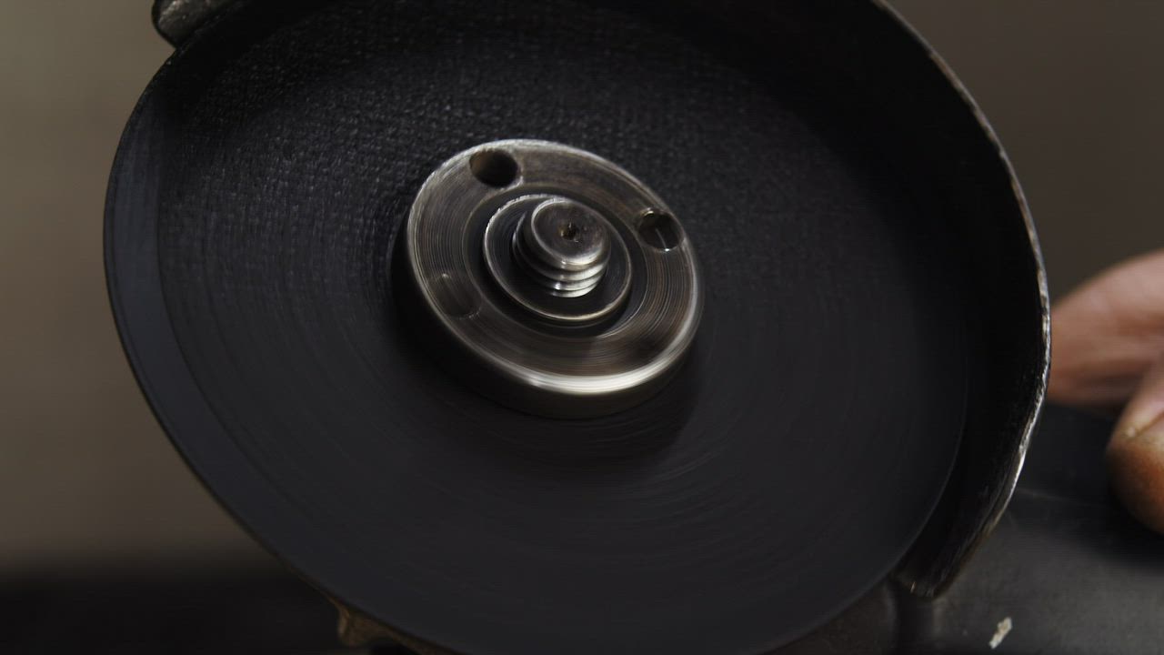 Close up shot of an angle grinder starting up - Free Stock Video