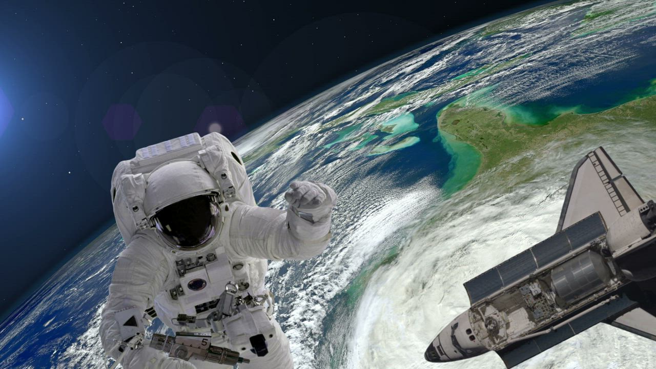 Astronaut wearing a space suit floating through space above Earth - Free Stock Video