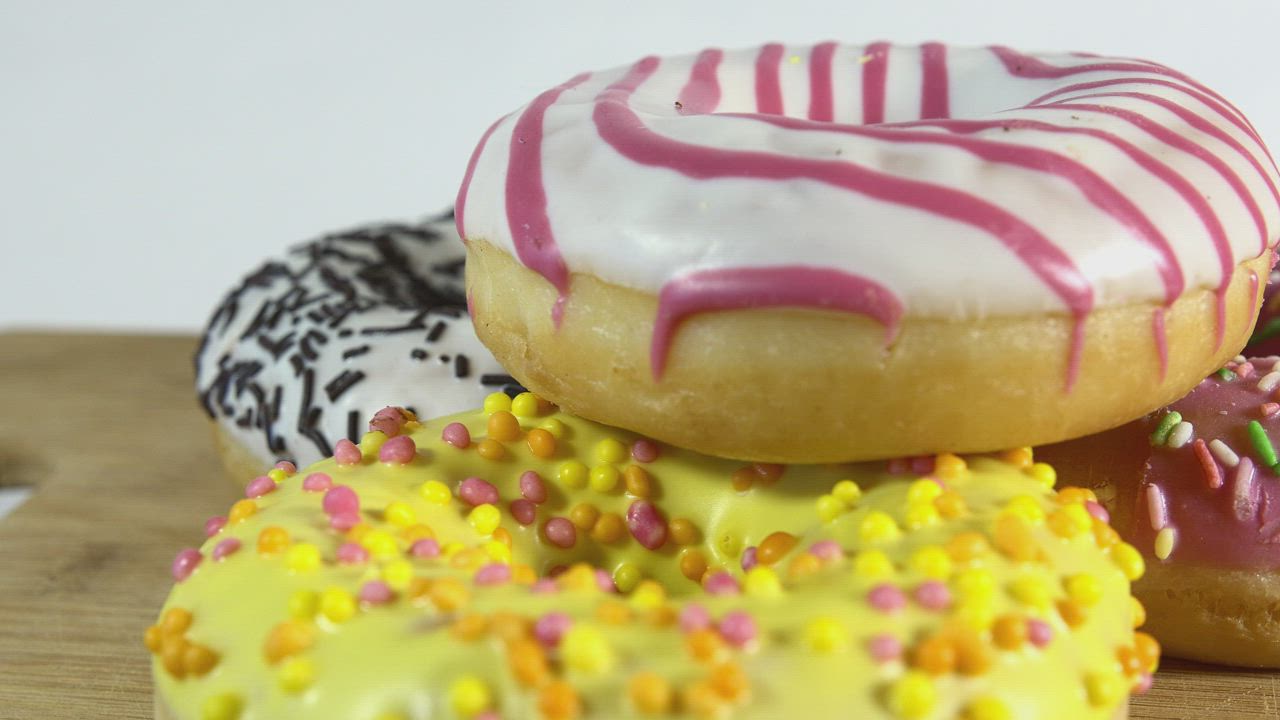 Stack of yummy donuts rotating slowly - Free Stock Video