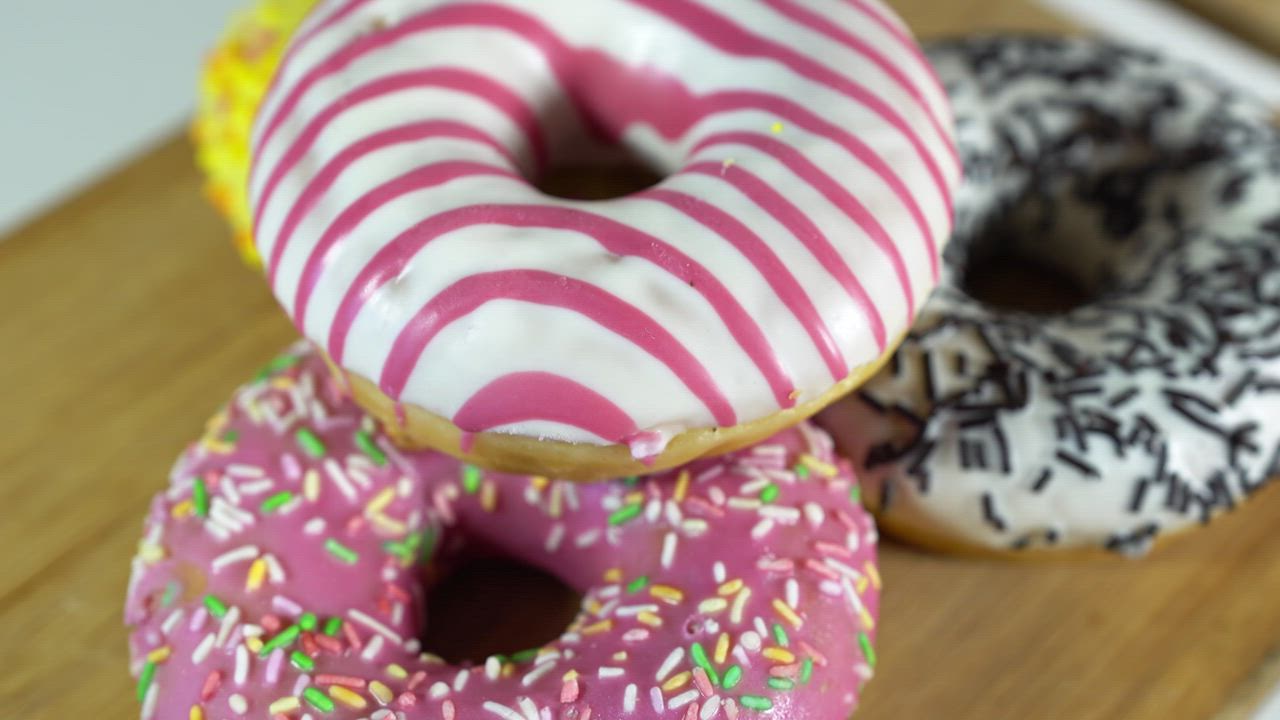 Arial shot of a pile of donuts rotating slowly on a wooden board - Free ...