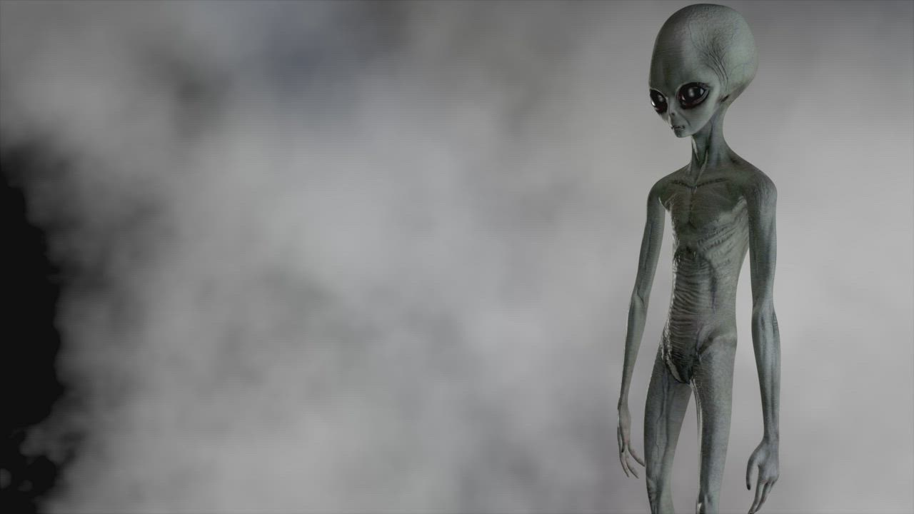 Spooky grey Alien standing and blinking along a grey smoky background ...