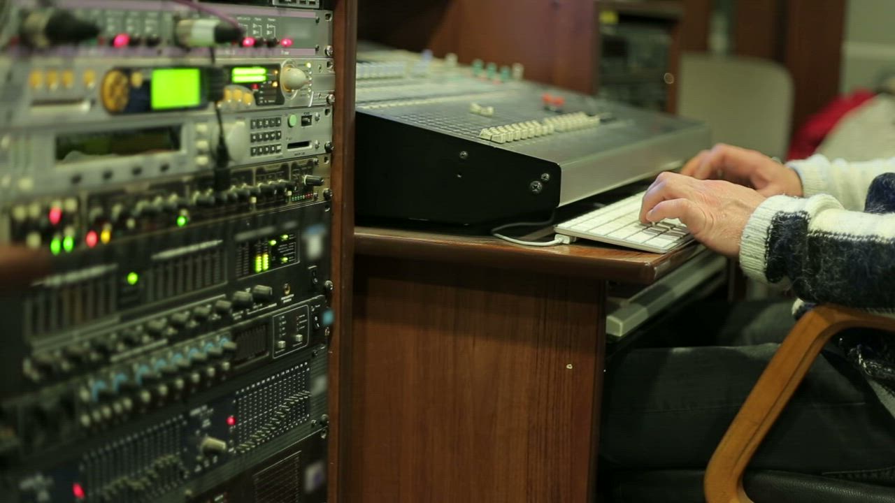 Sound engineer working on a keyboard - Free Stock Video