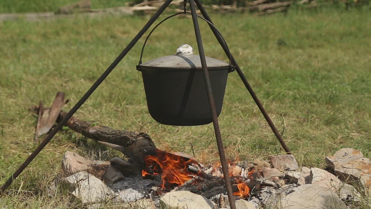 Outdoor cooking in a campfire cauldron - Free Stock Video