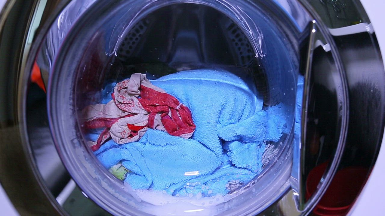 Washing machine spinning with dirty laundry - Free Stock Video