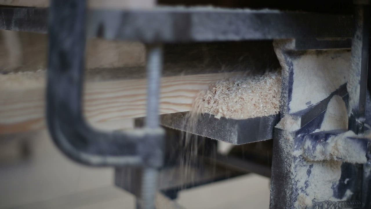 Circular saw cuts through timber planks - Free Stock Video