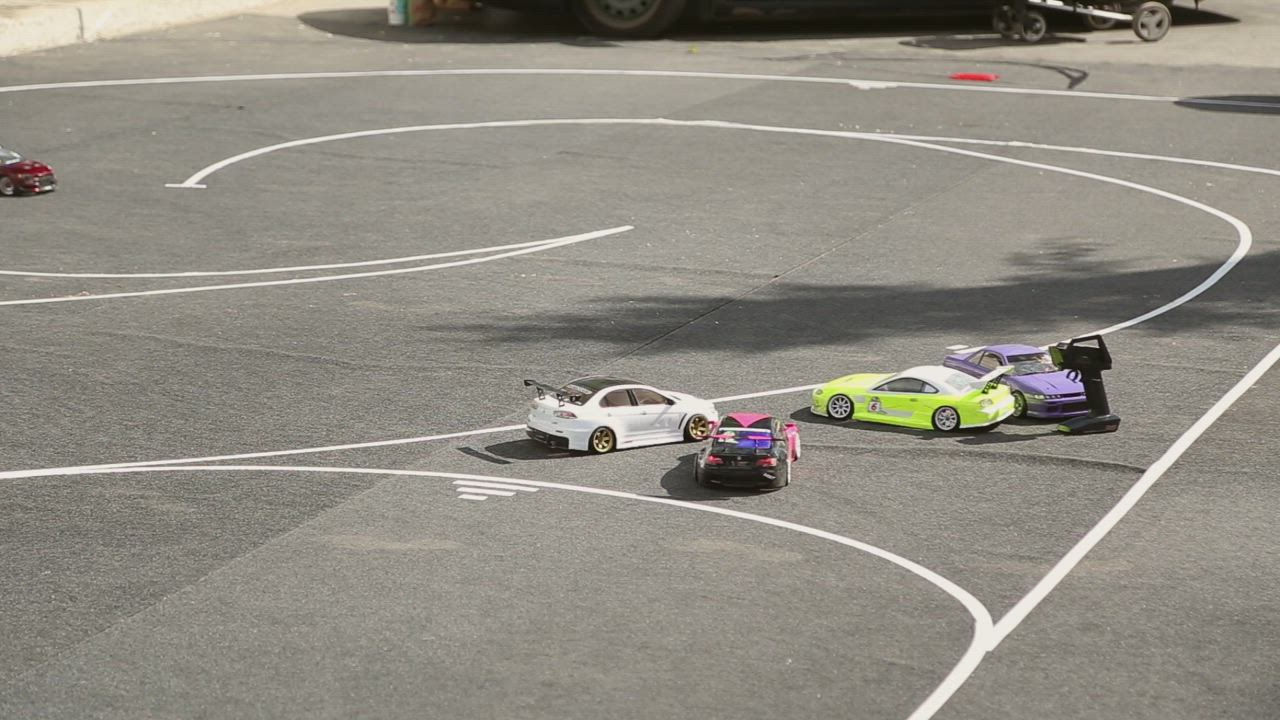 Red toy car spinning around a race track - Free Stock Video