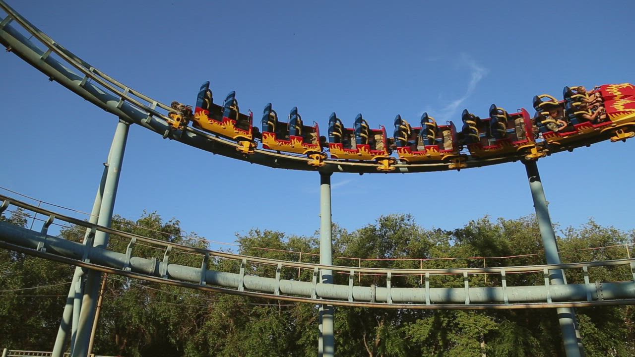 Fast rollercoaster ride moving along a loop - Free Stock Video