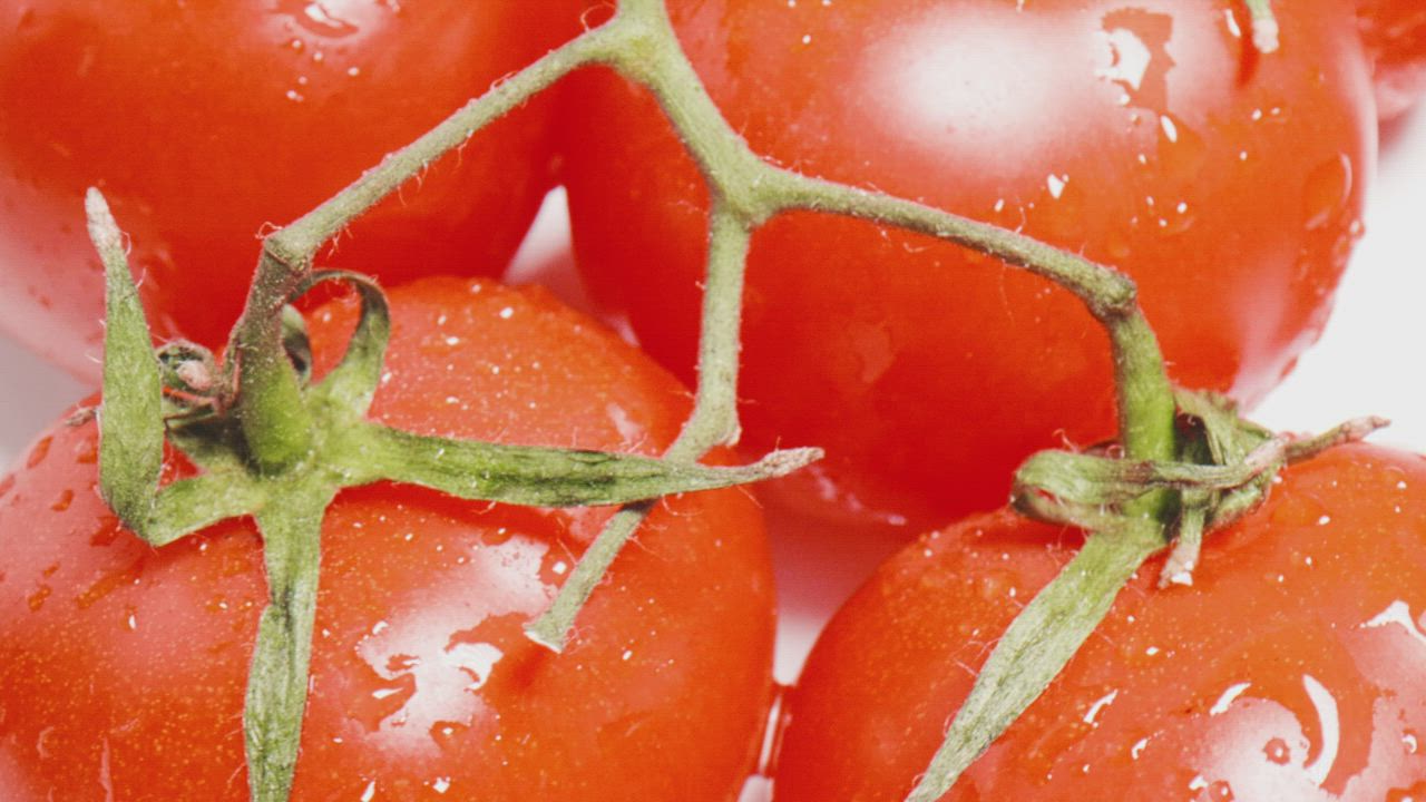 Close up of wet tomatoes spinning - Free Stock Video