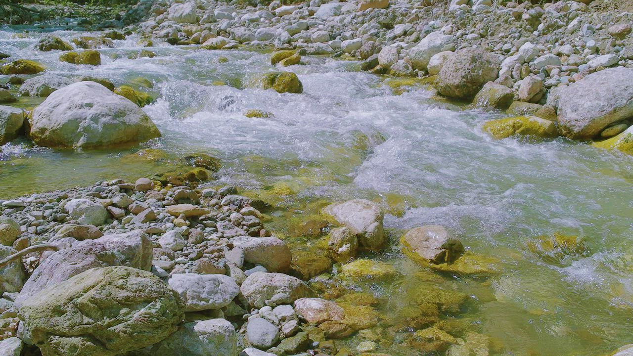 Water running down rocks in a river - Free Stock Video