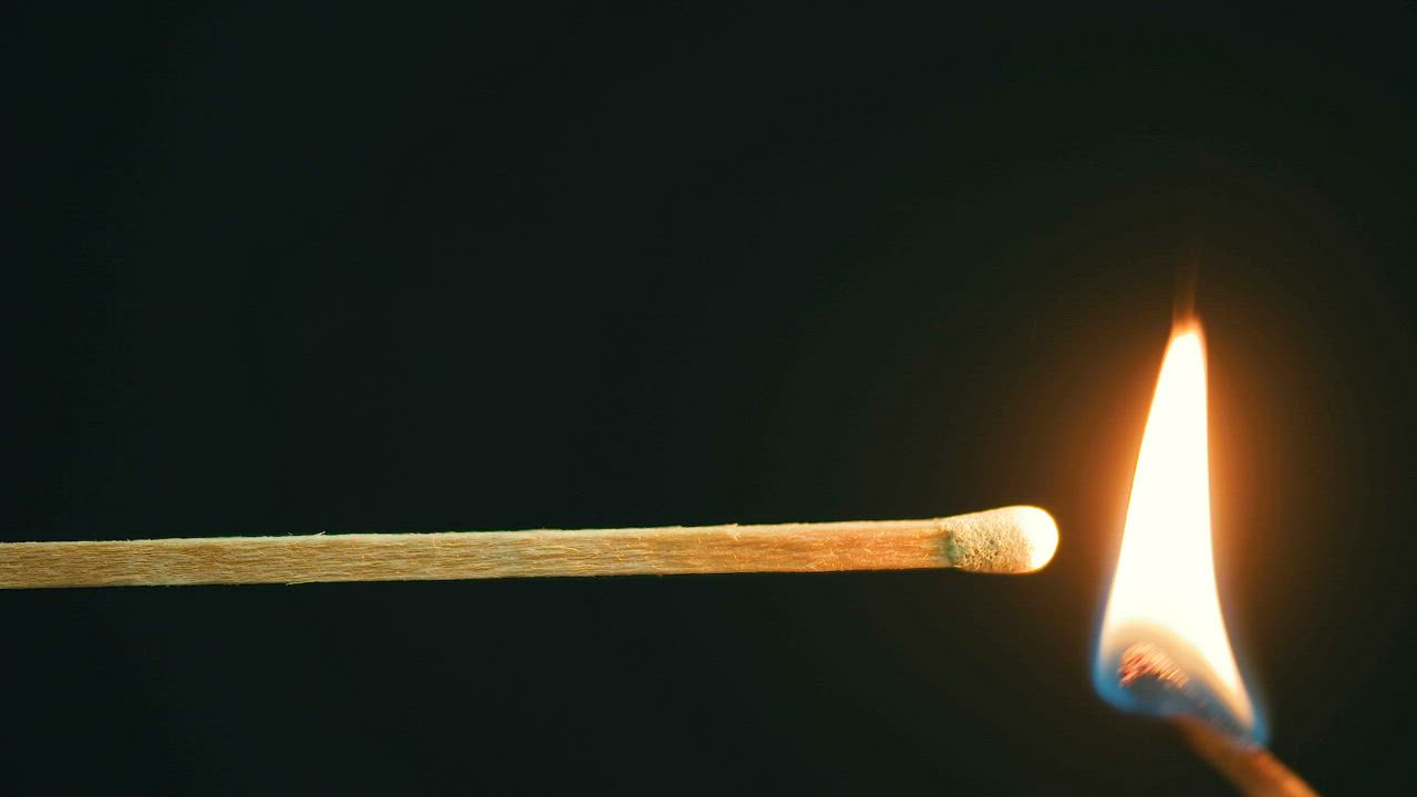 Head of a match catches alight by another match - Free Stock Video