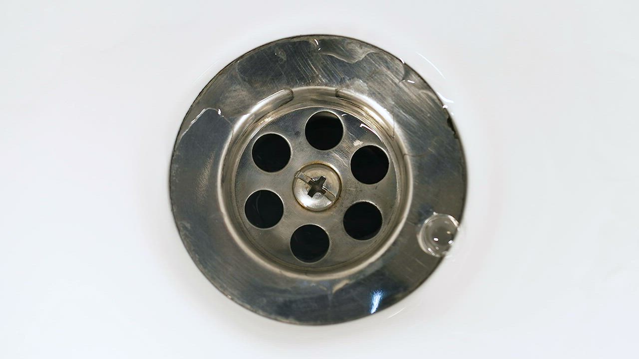 Water falls into a sink and flow down the drain - Free Stock Video