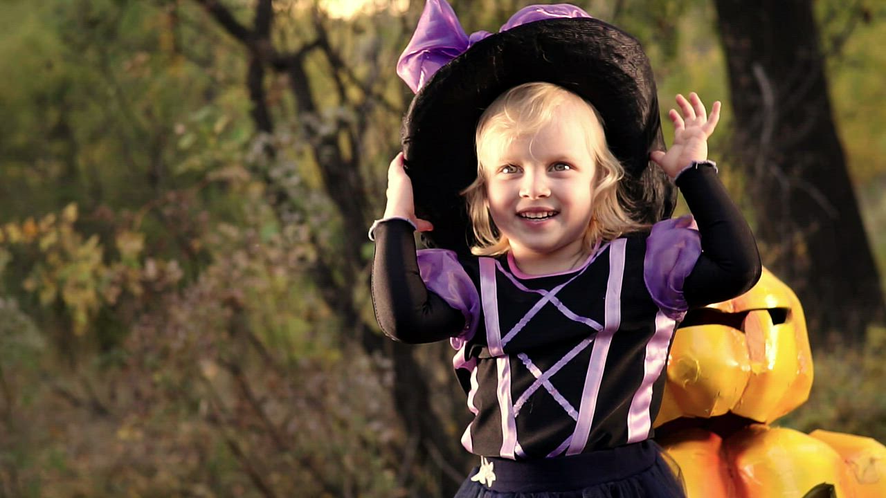 Little girl in witch costume dances happily - Free Stock Video