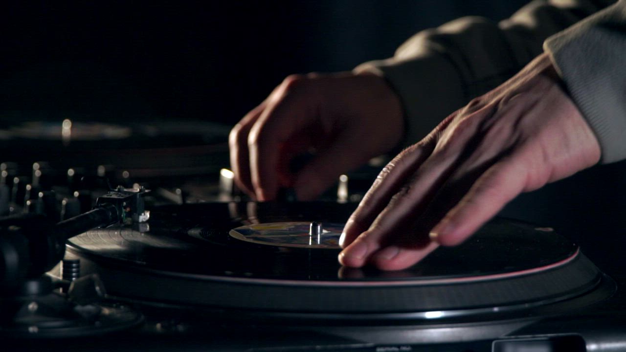 DJ scratching a vinyl on a turntable - Free Stock Video
