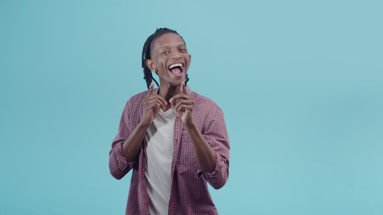 Happy man dancing cheerfully on a blue background - Free Stock Video