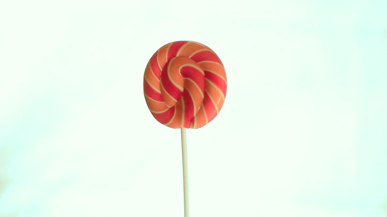 Lollipop spinning against a white background - Free Stock Video