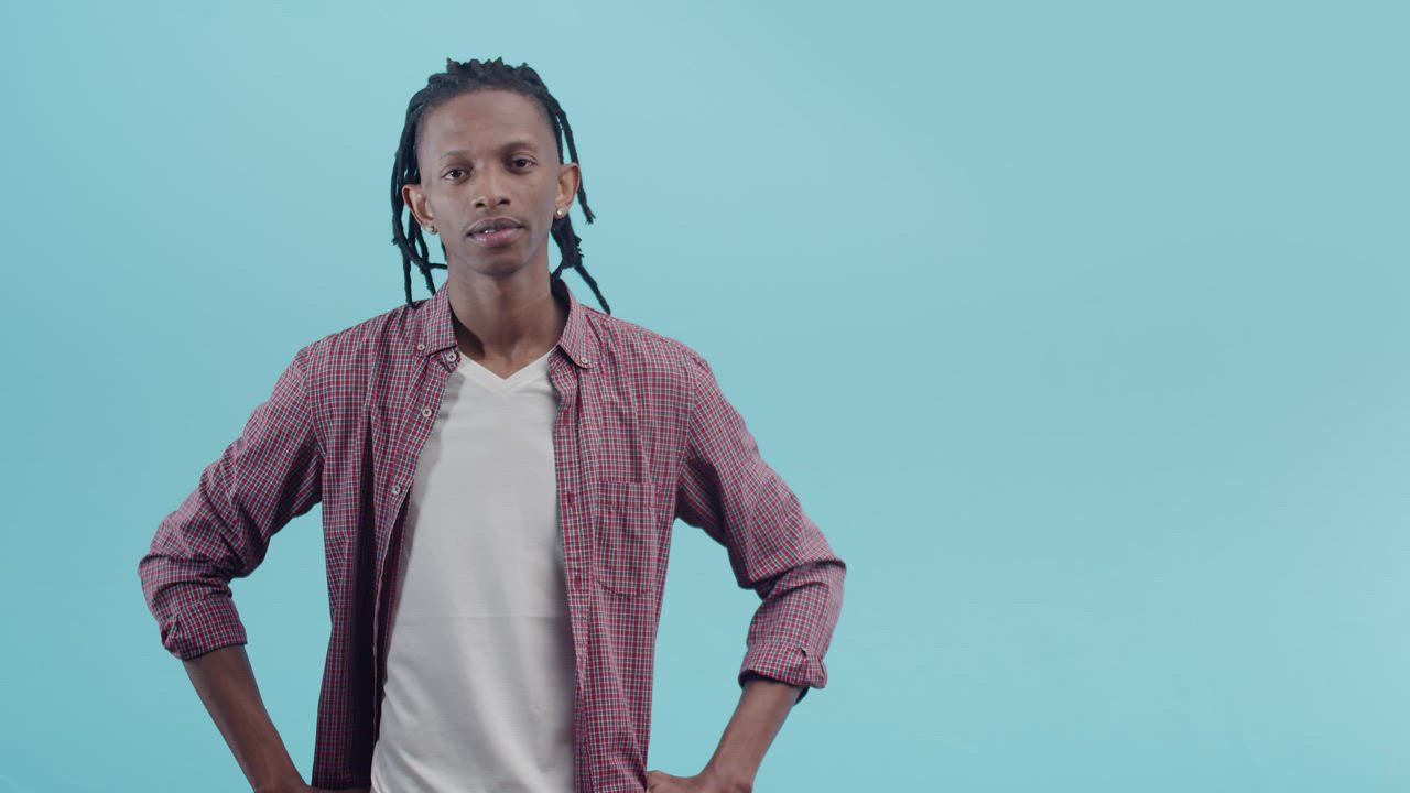 Man on a blue background points at himself in surprise - Free Stock Video