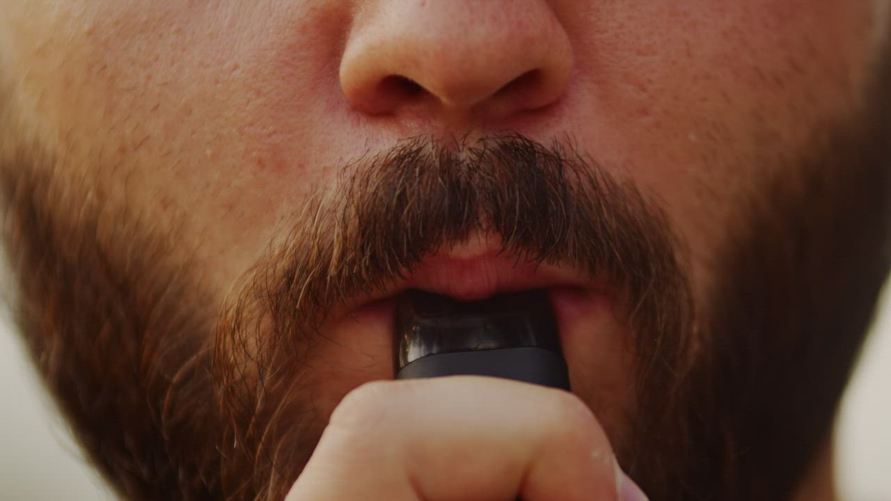 Close up of a man inhaling a vape - Free Stock Video