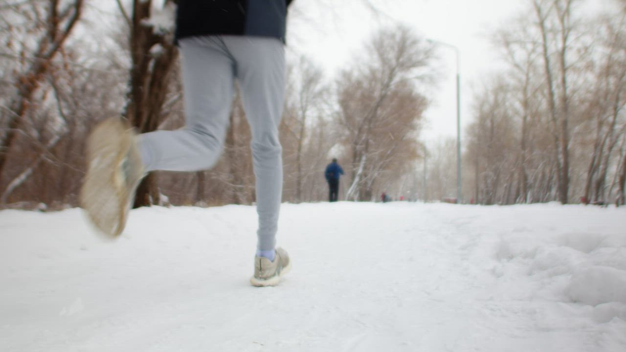 Person running in slow motion through the snow - Free Stock Video