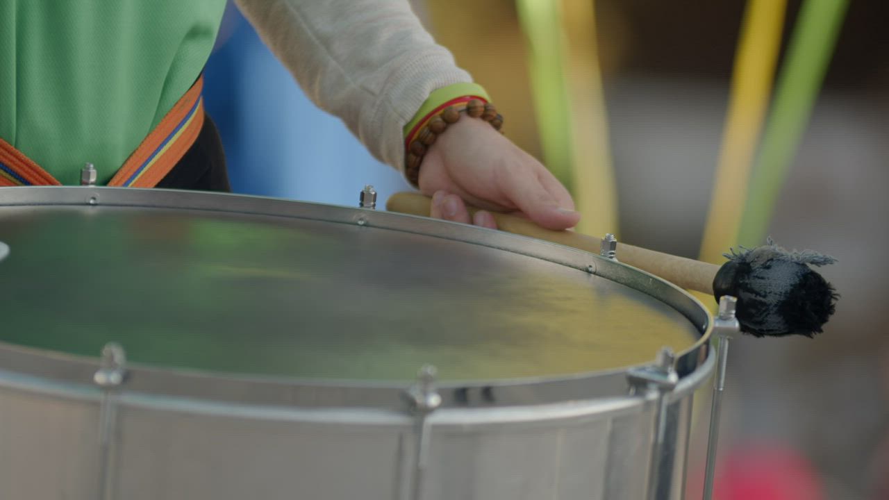 Close up of a musician tapping a rhythm on a hanging drum - Free Stock ...