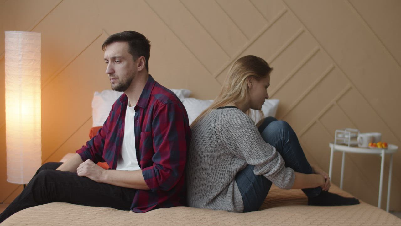 A couple sitting with their backs to each other after an argument ...