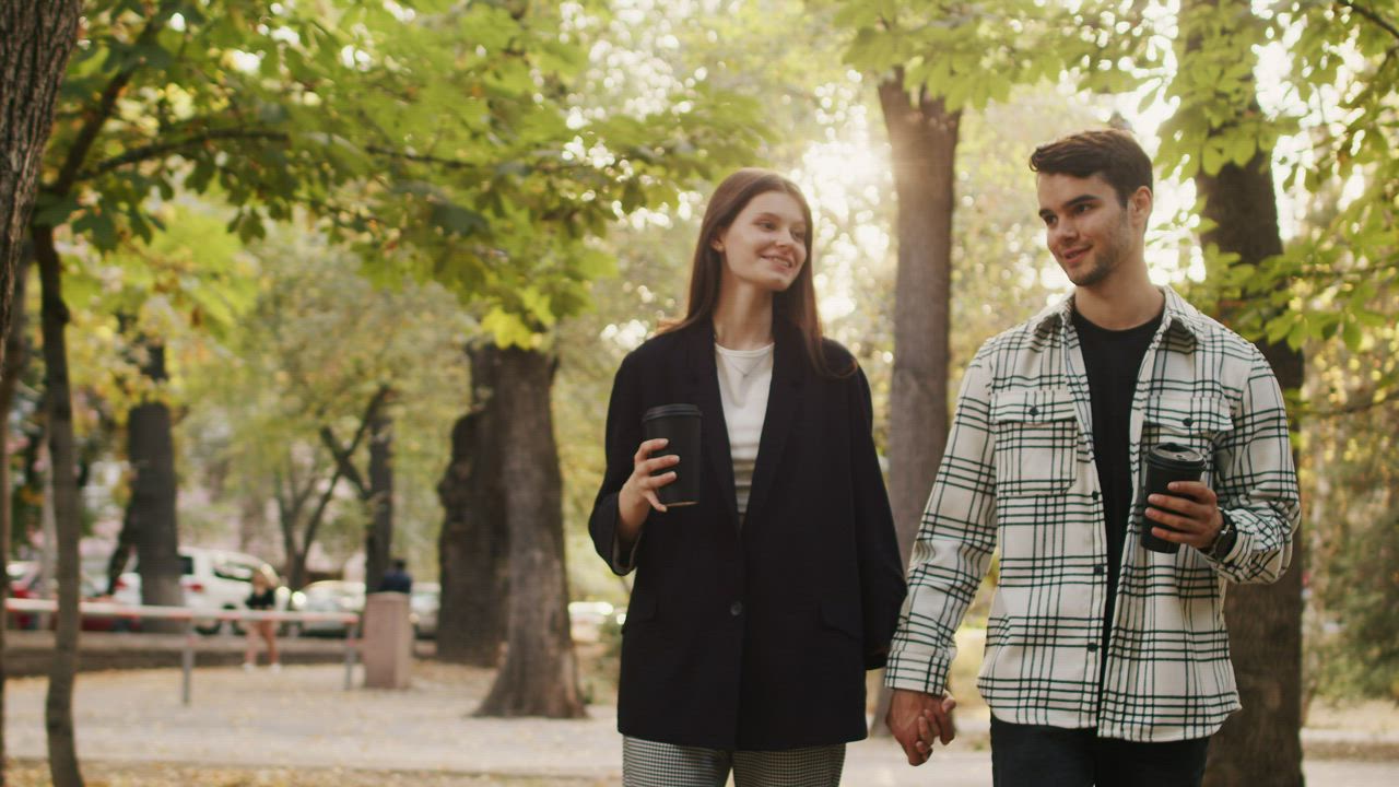 Couple taking a romantic walk during a morning coffee run - Free Stock ...
