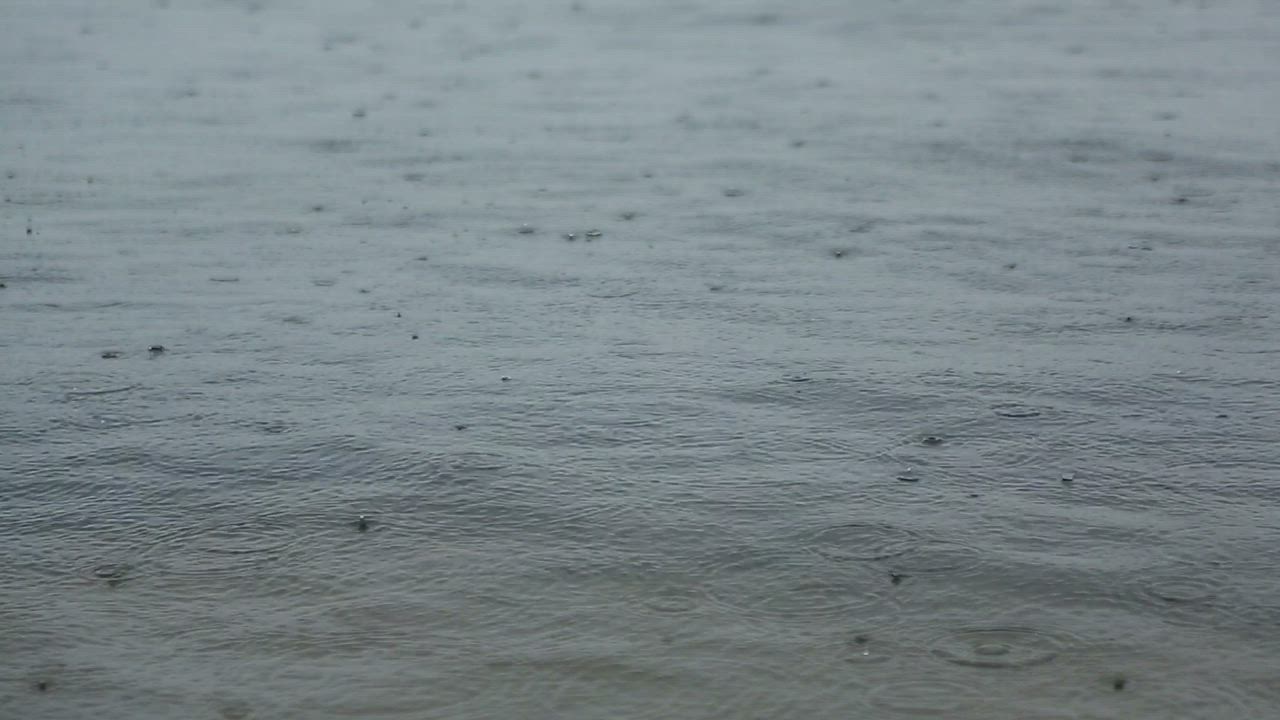 Rain drops on river water - Free Stock Video
