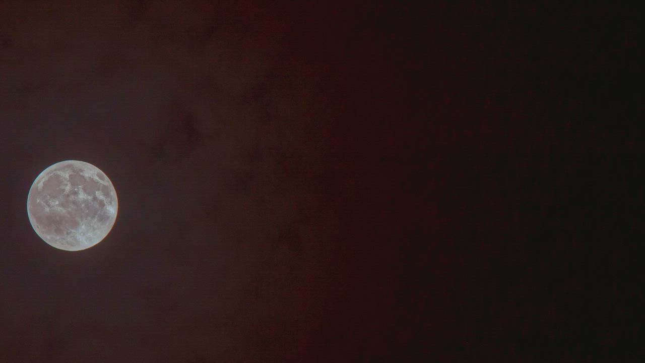 Mysterious red full moon moves across the sky - Free Stock Video