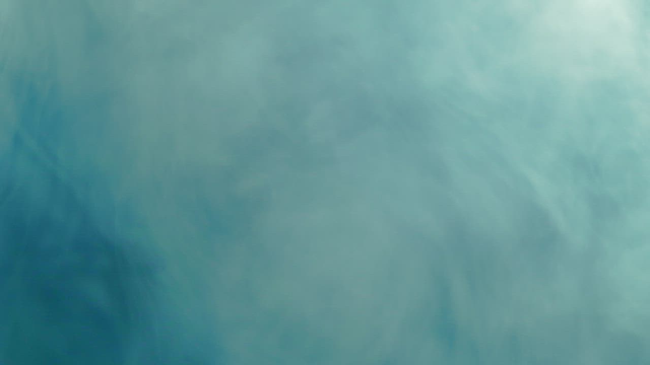 Blue smoke rising in front of a black background - Free Stock Video